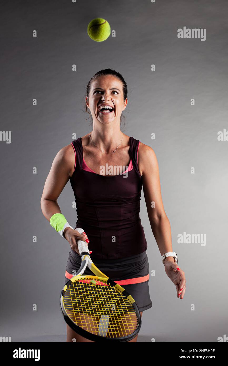 Professional female tennis player. Girl swinging racket Stock Photo - Alamy