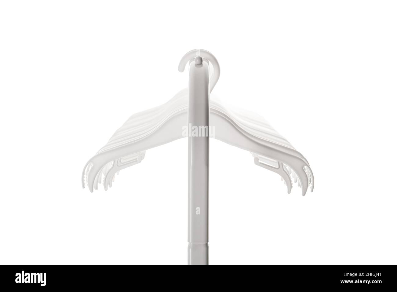 White plastic hangers for clothes hanging on rod from clothing rack ...