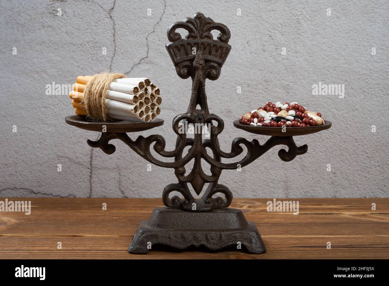 cigarettes and medicine on a balanced scale concept of unhealthy ...