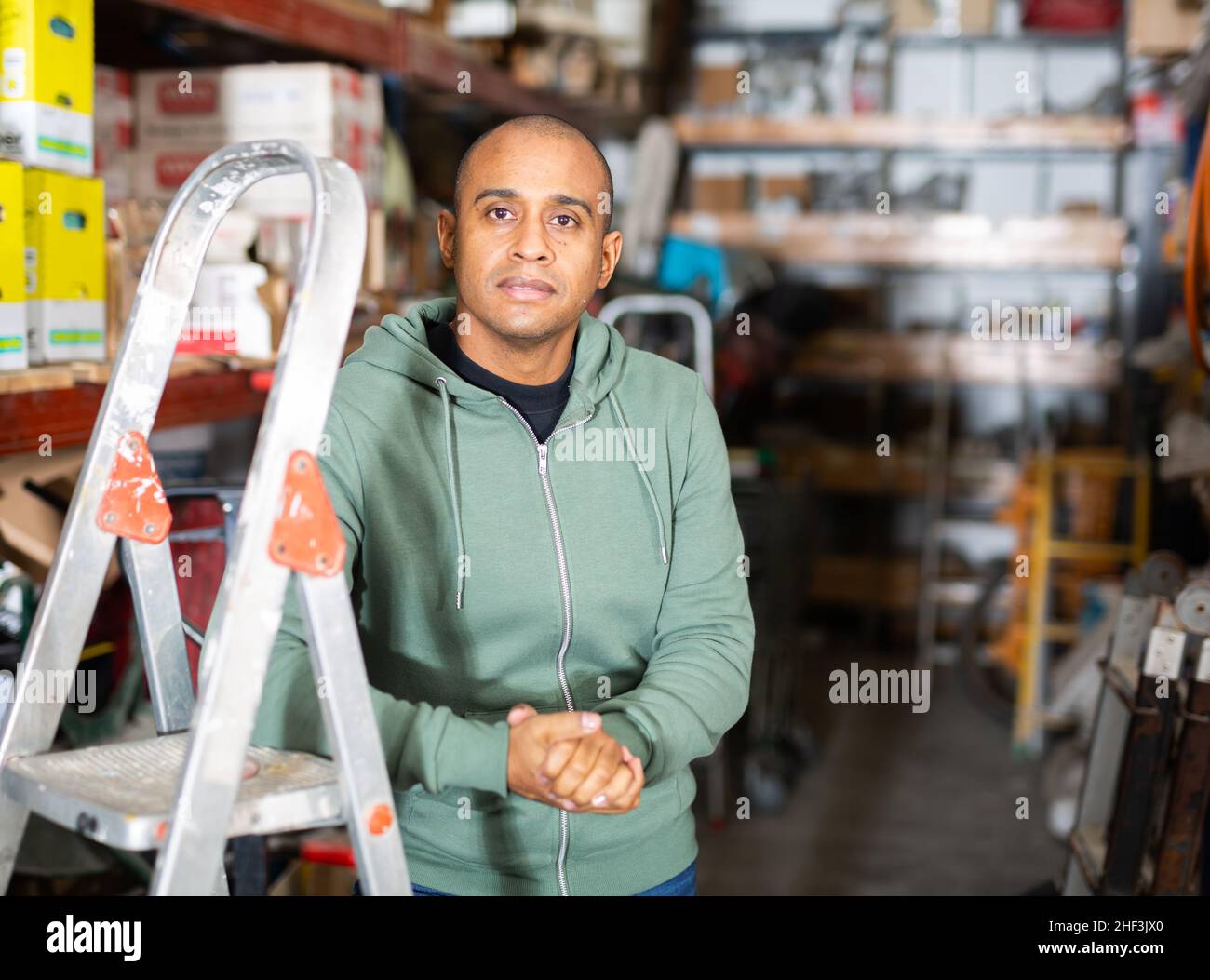 Confident Hispanic man owner of building materials store Stock Photo ...