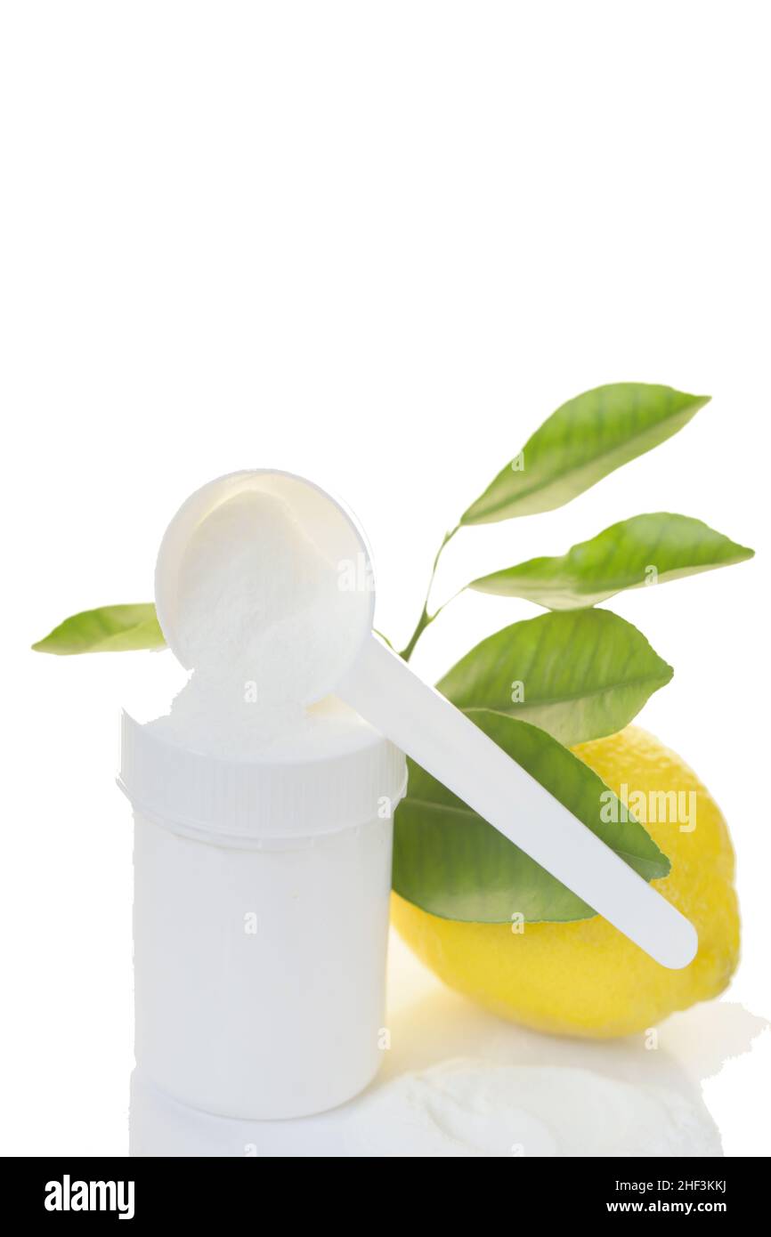 Vitamin C. Vitamin C powder, white measuring spoon, white jar and lemon ...