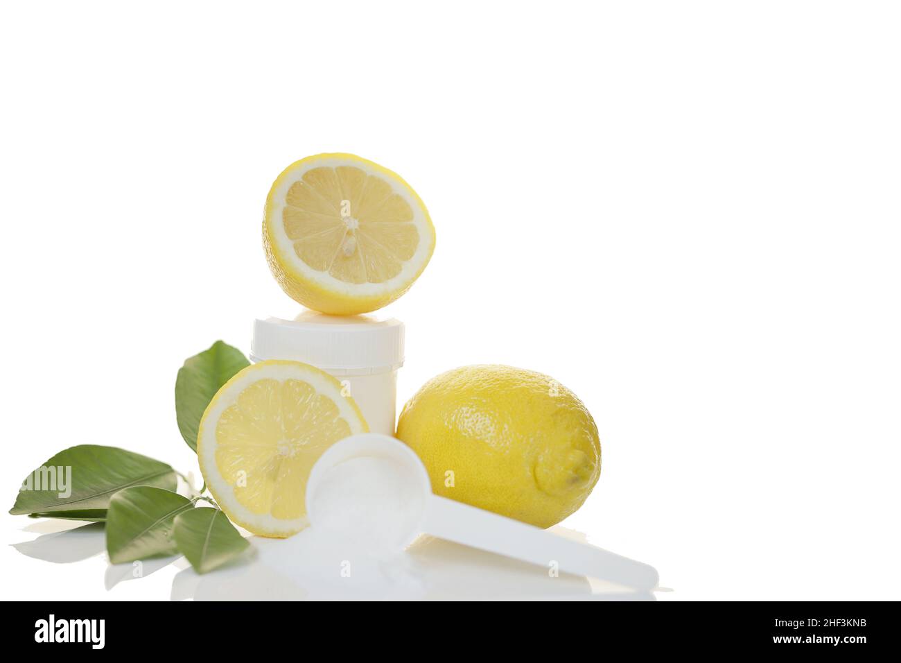 Vitamin C. Vitamin C powder, white measuring spoon, white jar and lemon ...