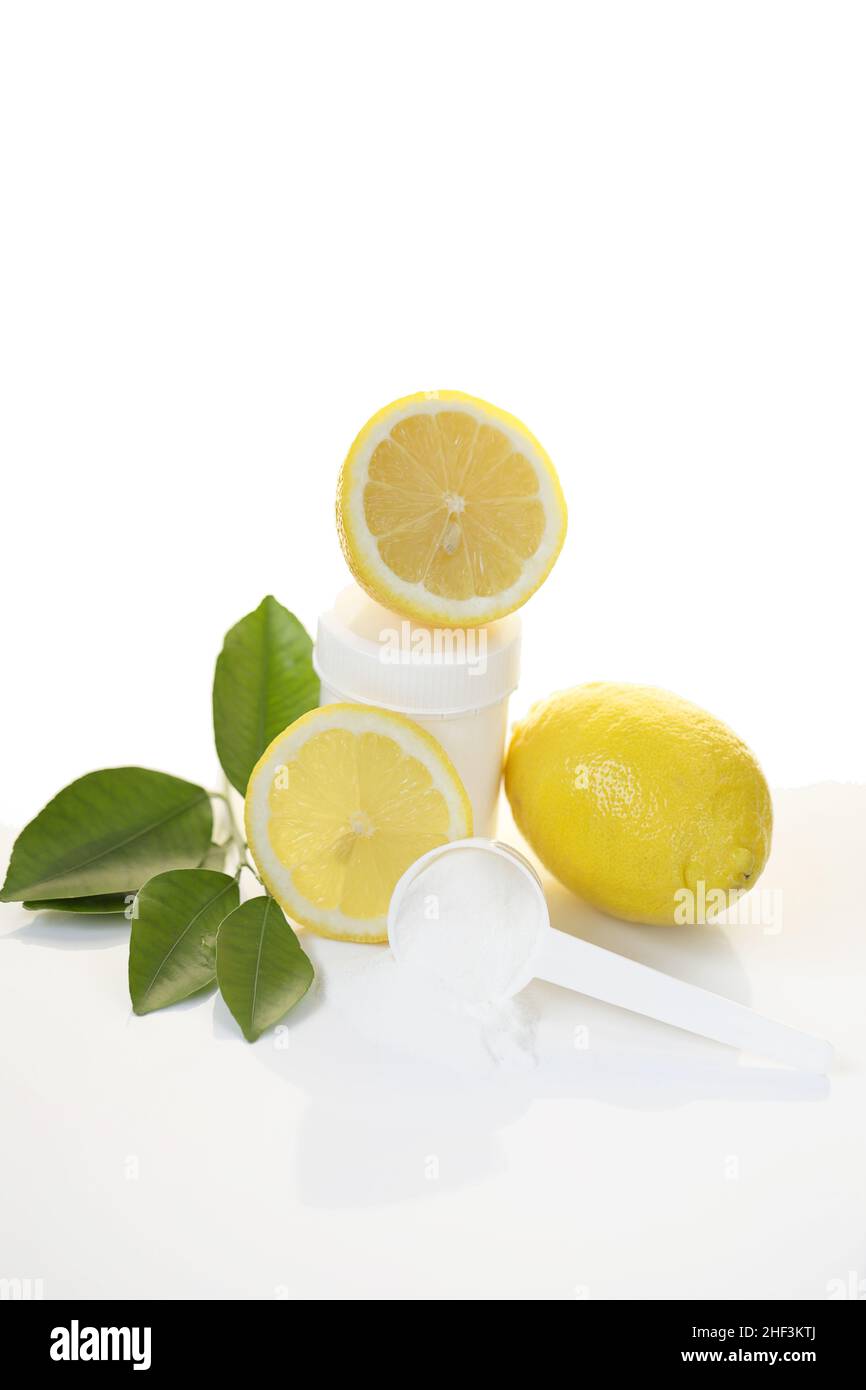Vitamin C. Vitamin C powder,measuring spoon, white jar and lemon with ...