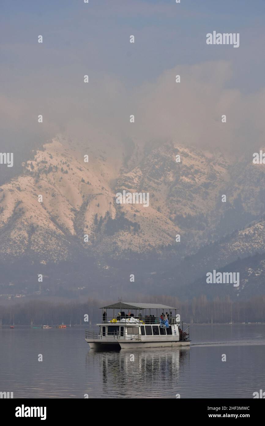 Tourists seen enjoying on the passenger ferry during a cold winter day ...