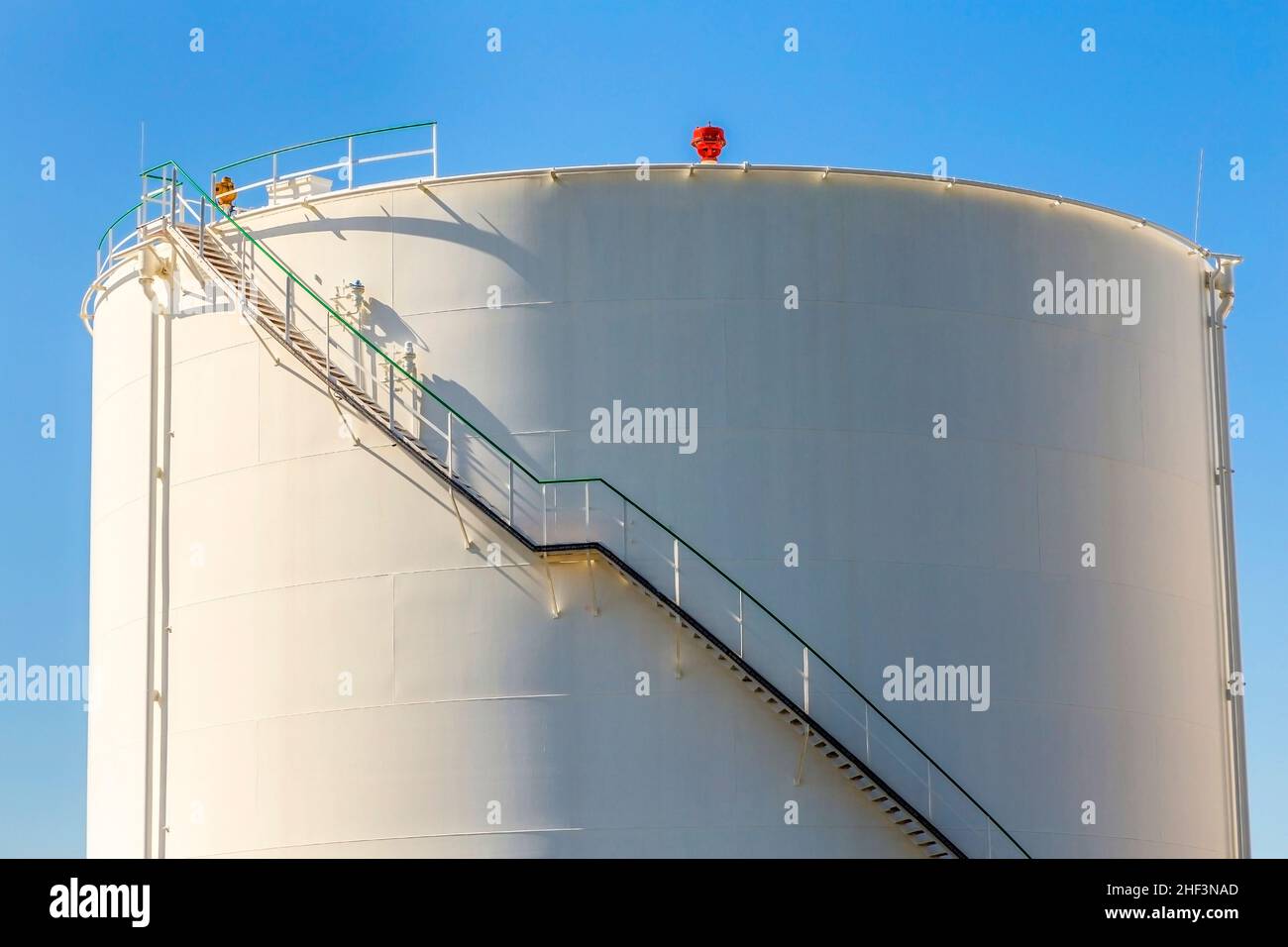 white tanks in tank farm with iron staircase under blue sky Stock Photo ...