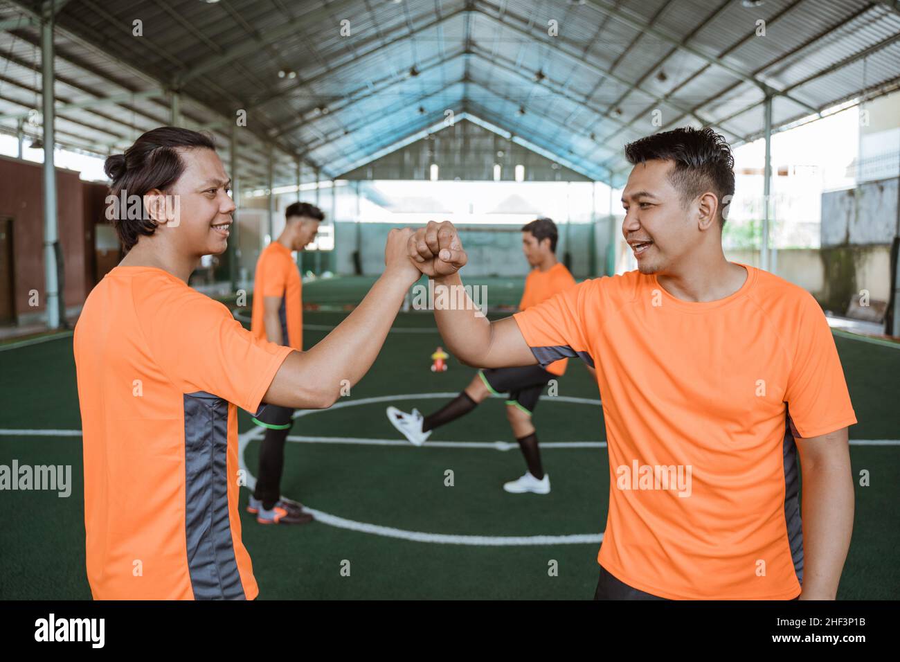 Two futsal players cheer up with their arms before competing Stock ...