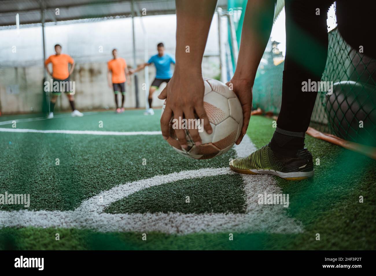 two player hands holding the ball taking a corner kick Stock Photo - Alamy