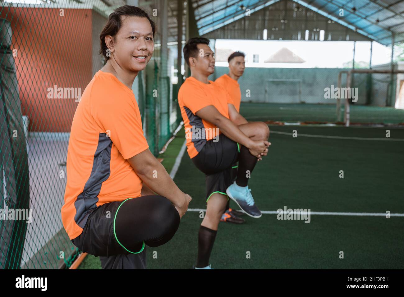futsal players smile while stretching their legs before the game Stock ...