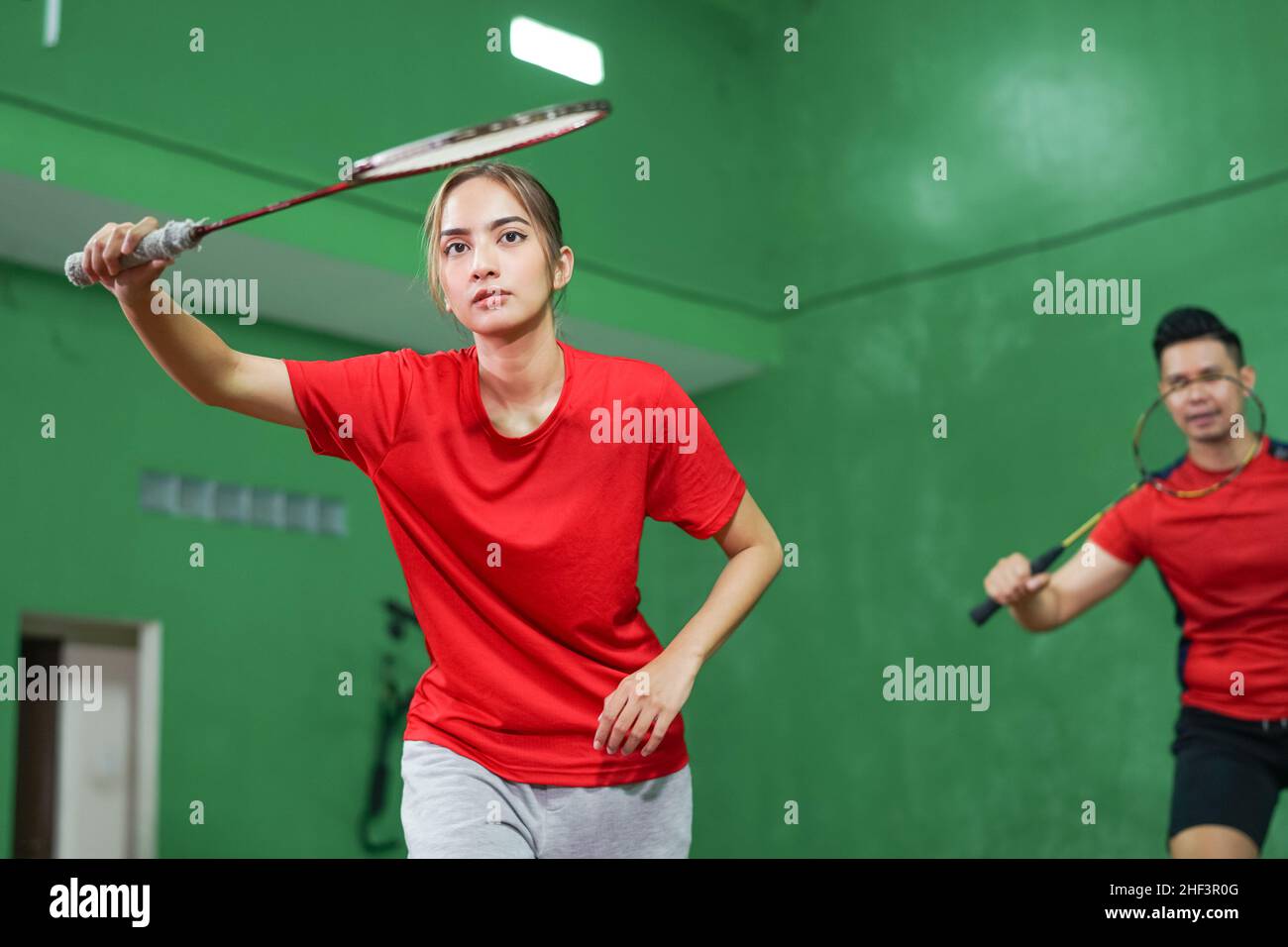 Female badminton player ready to hold the racket Stock Photo - Alamy