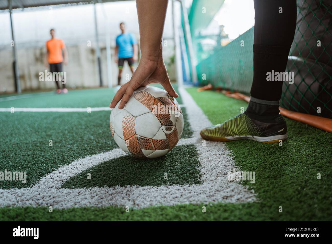 The player's hand holding the ball takes a corner kick Stock Photo - Alamy