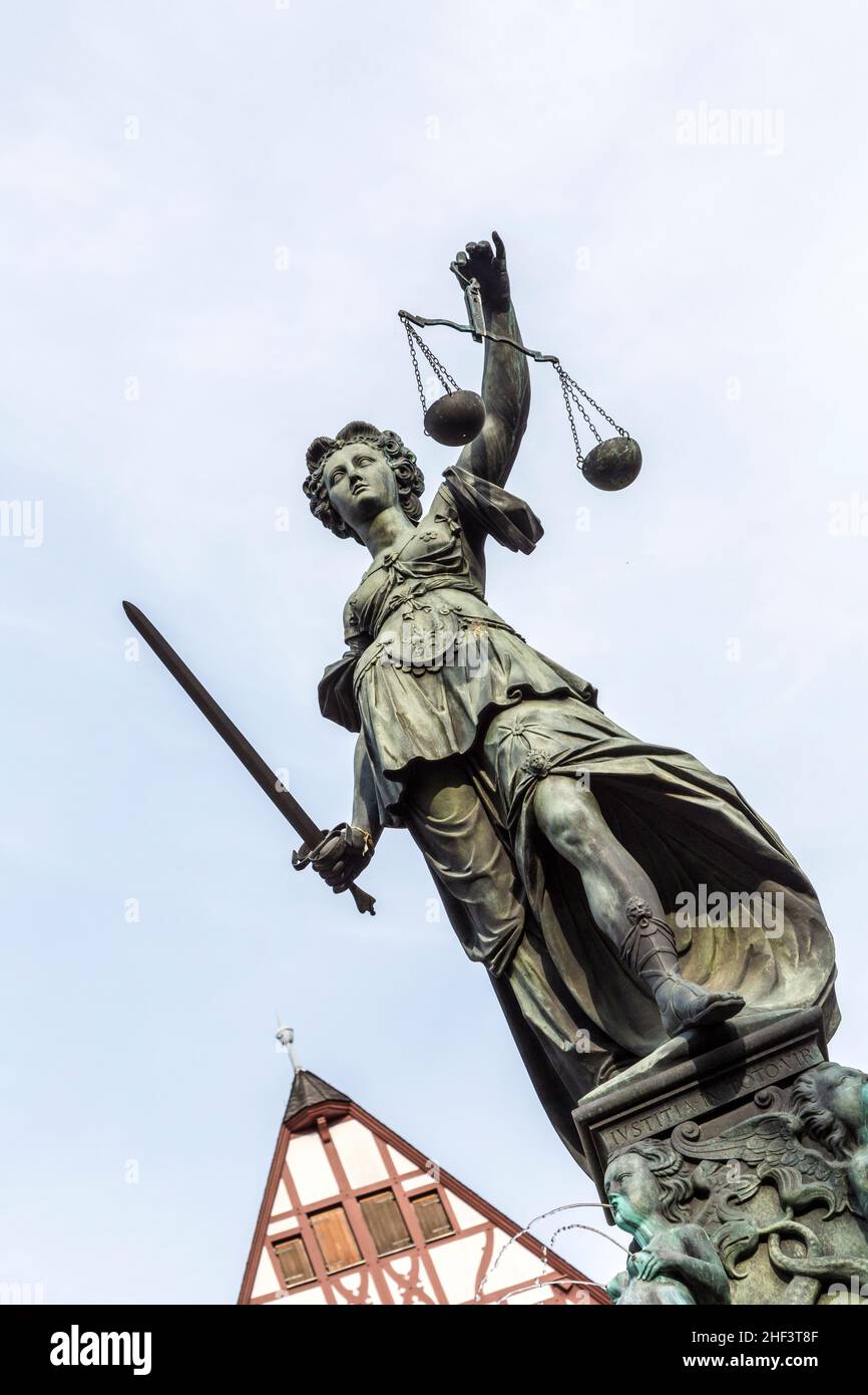 Justitia Statue at the Romer square under blue sky Stock Photo - Alamy