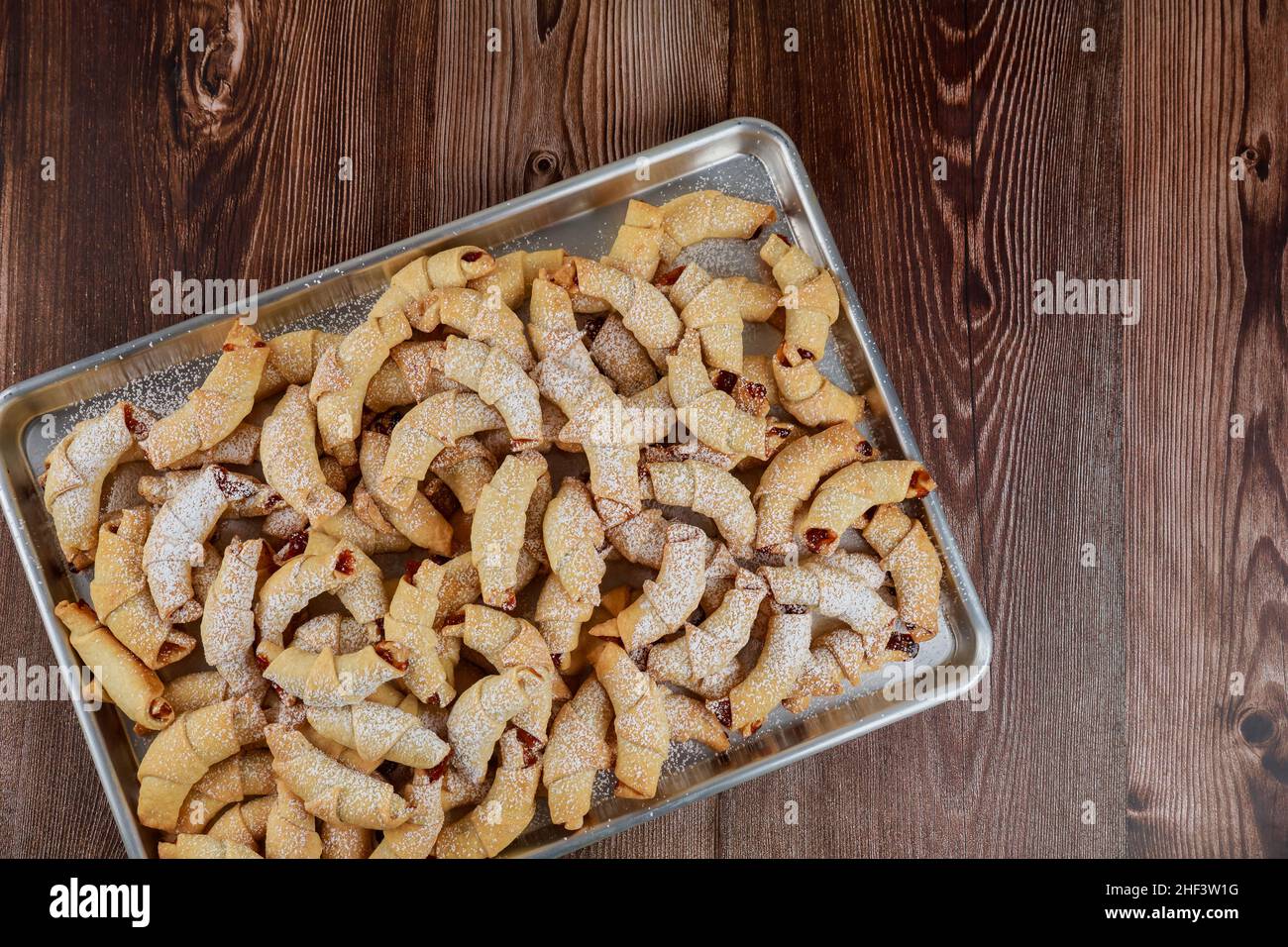 Baked crescent cookies with jam and powdered sugar Stock Photo - Alamy