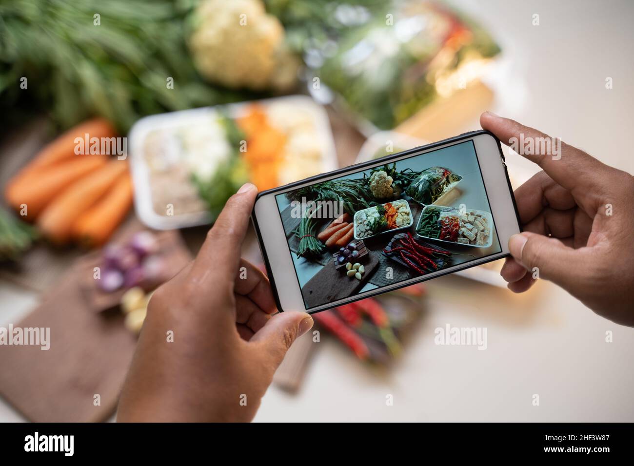 Photo with a mobile phone with fresh vegetables background Stock Photo ...