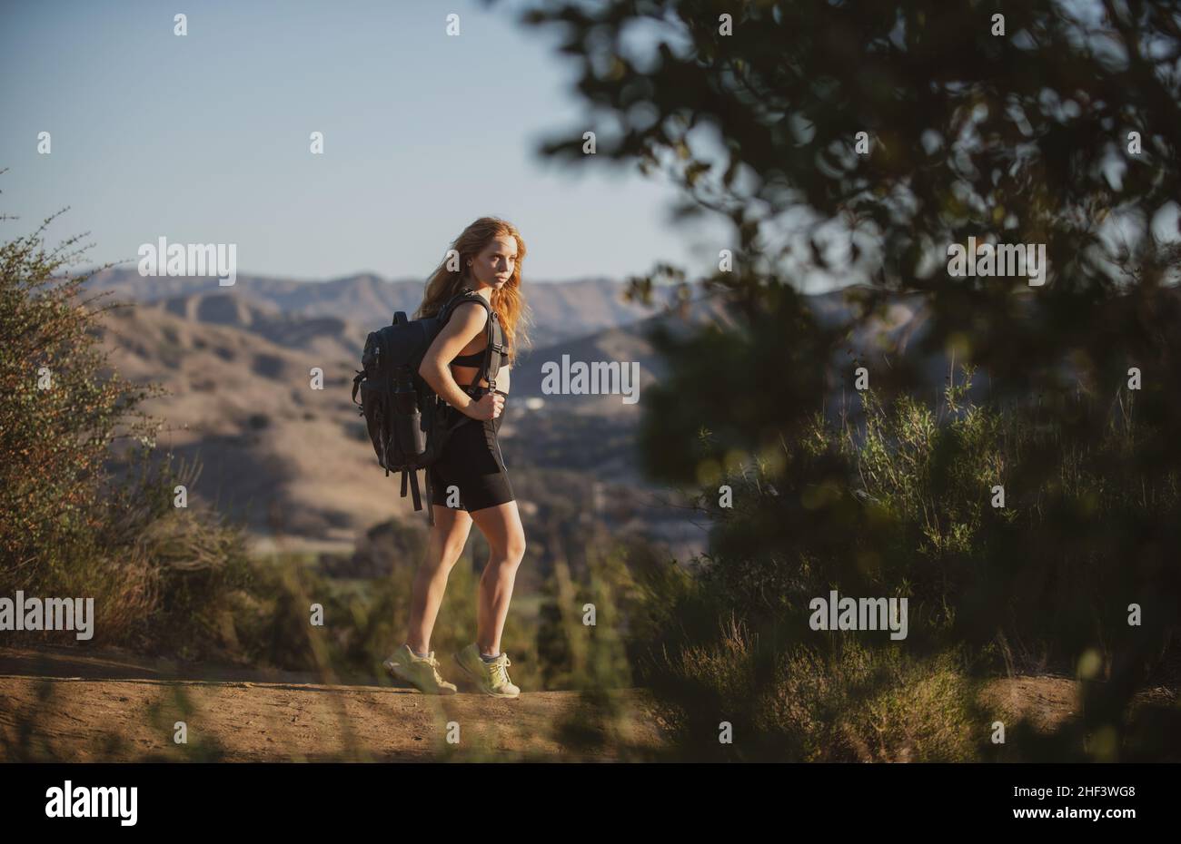 Hiker girl hiking mountain with backpack. Sporty girl looking at the ...