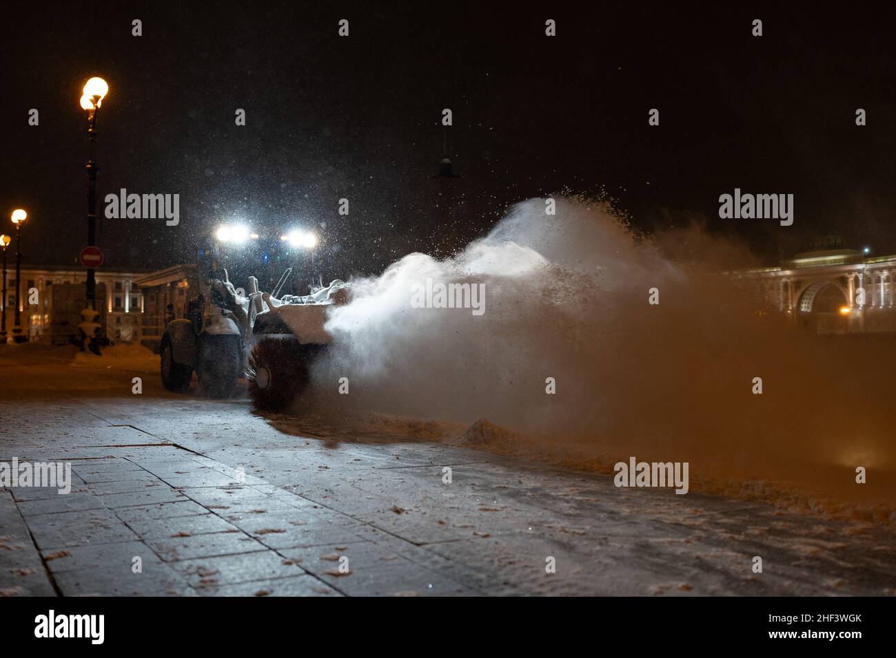 Winter service vehicles. Big yellow snow plow tractor working in city ...