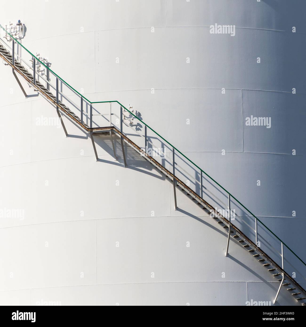 white tanks in tank farm with iron staircase under blue sky Stock Photo ...