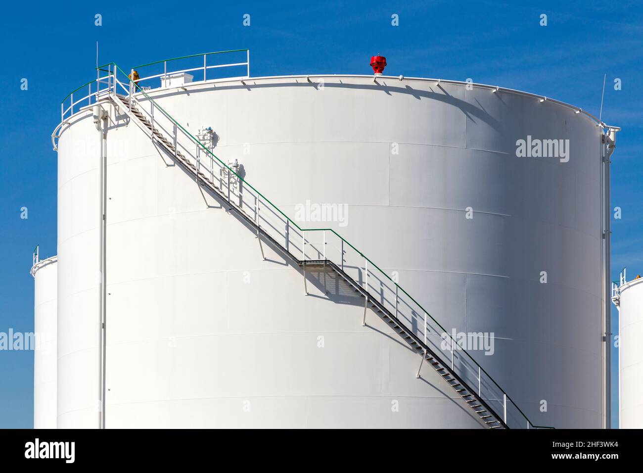 white tanks in tank farm with iron staircase under blue sky Stock Photo ...