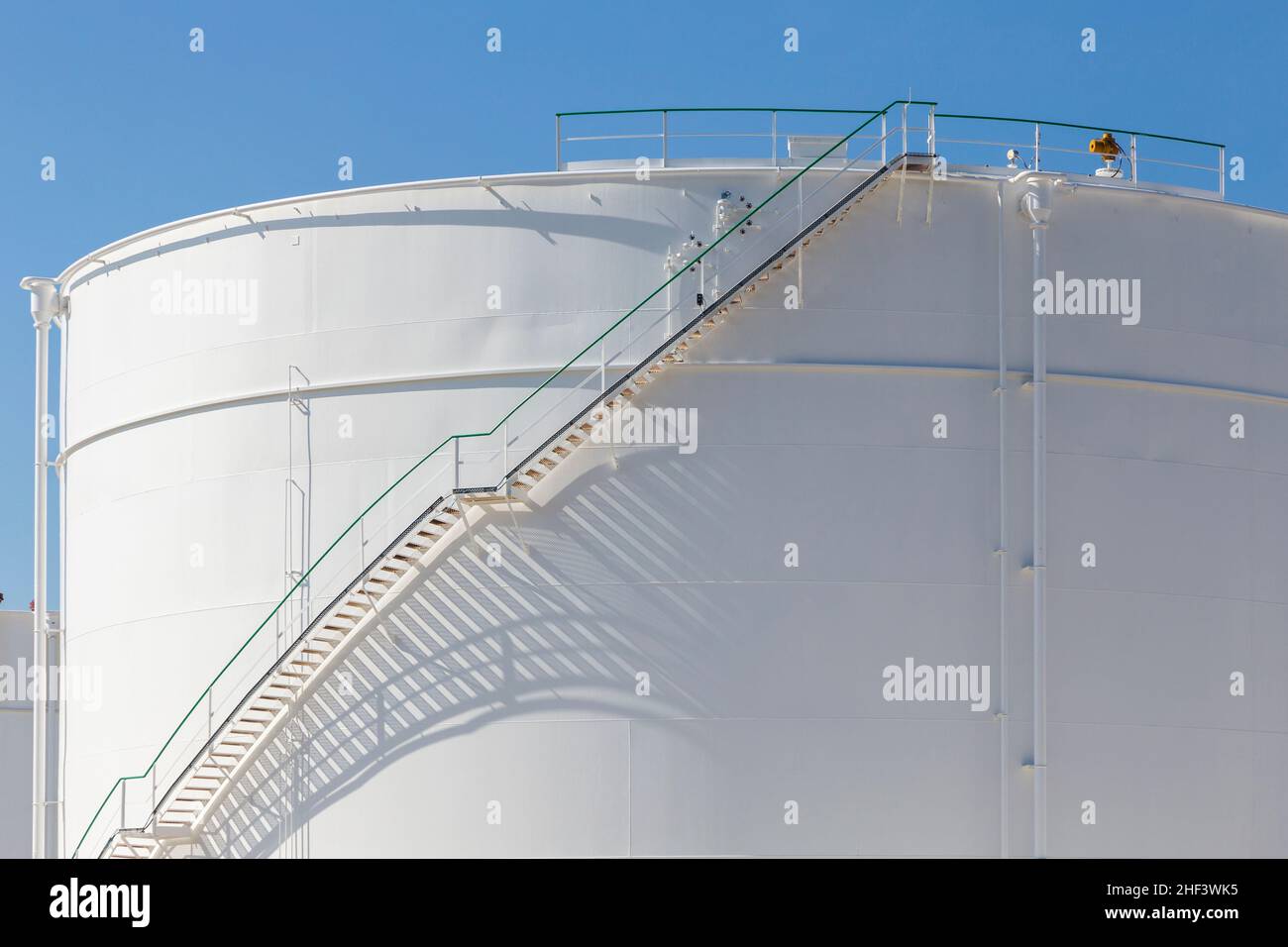white tanks in tank farm with iron staircase under blue sky Stock Photo ...