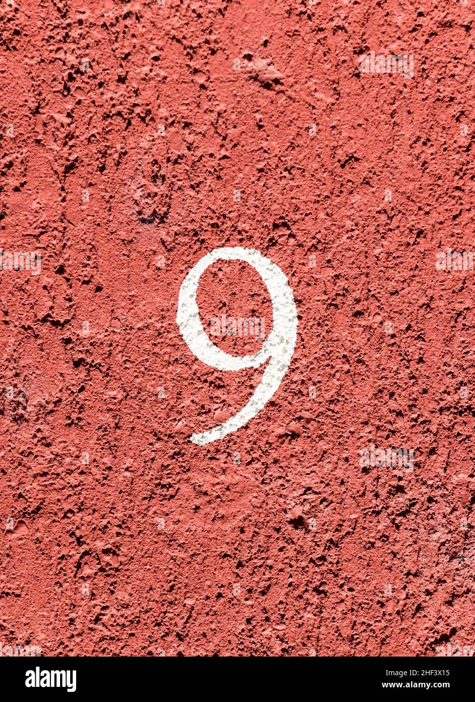 white House number 9 at red wall Stock Photo - Alamy