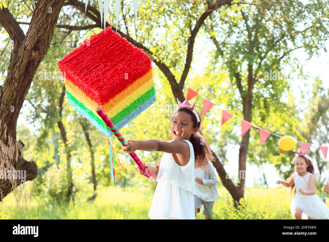 Cute children at pinata birthday party Stock Photo - Alamy