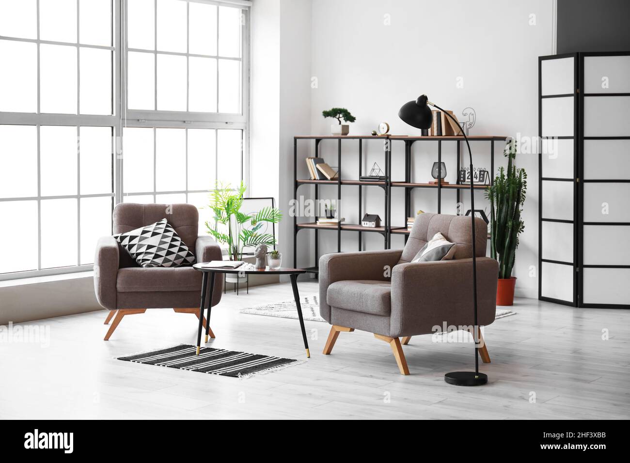 Interior of modern living room with comfortable armchairs Stock Photo ...