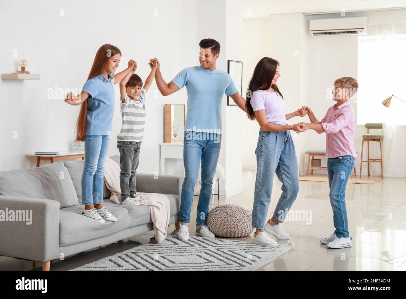 Happy family dancing at home Stock Photo - Alamy