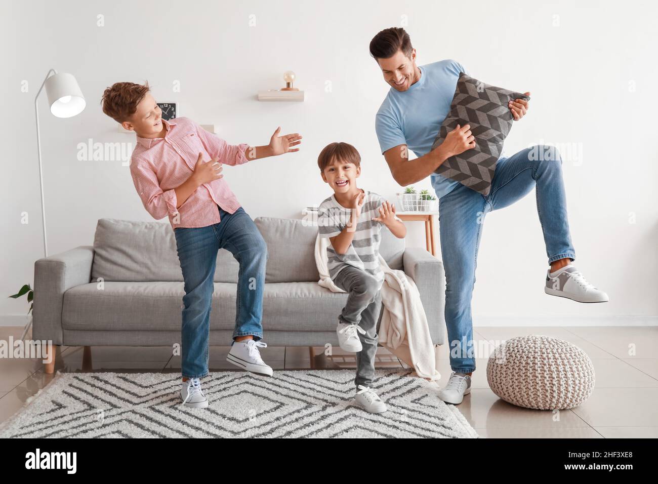 Happy man and his children dancing at home Stock Photo - Alamy