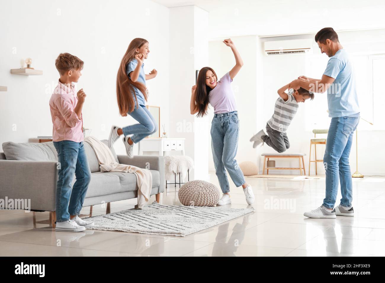 Happy family dancing at home Stock Photo - Alamy