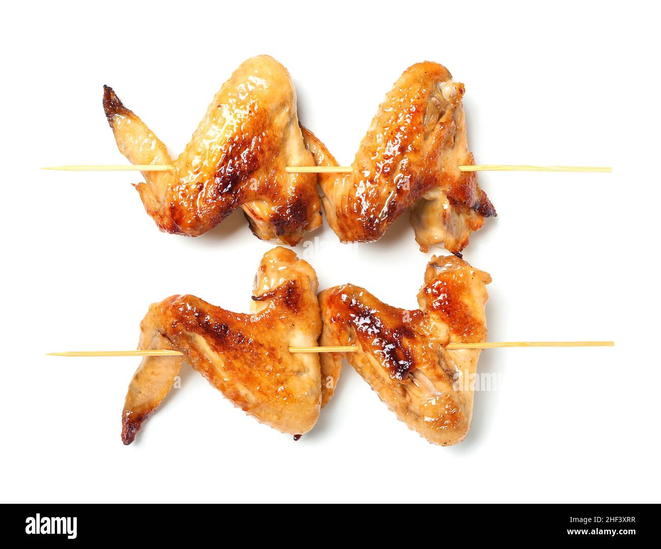 Grilled chicken wings skewers on white background Stock Photo - Alamy