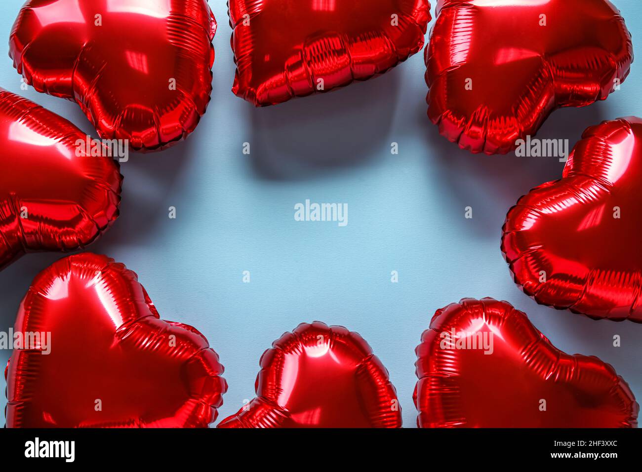 Frame made of heart-shaped air balloons for Valentine's day on blue ...