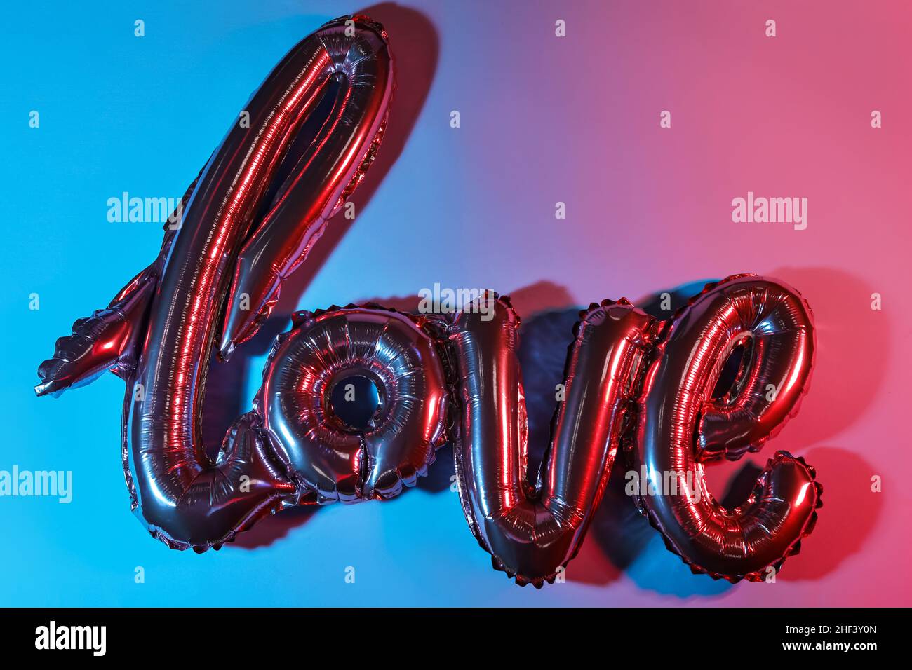 Balloon in shape of word LOVE on color background. Valentine's Day ...