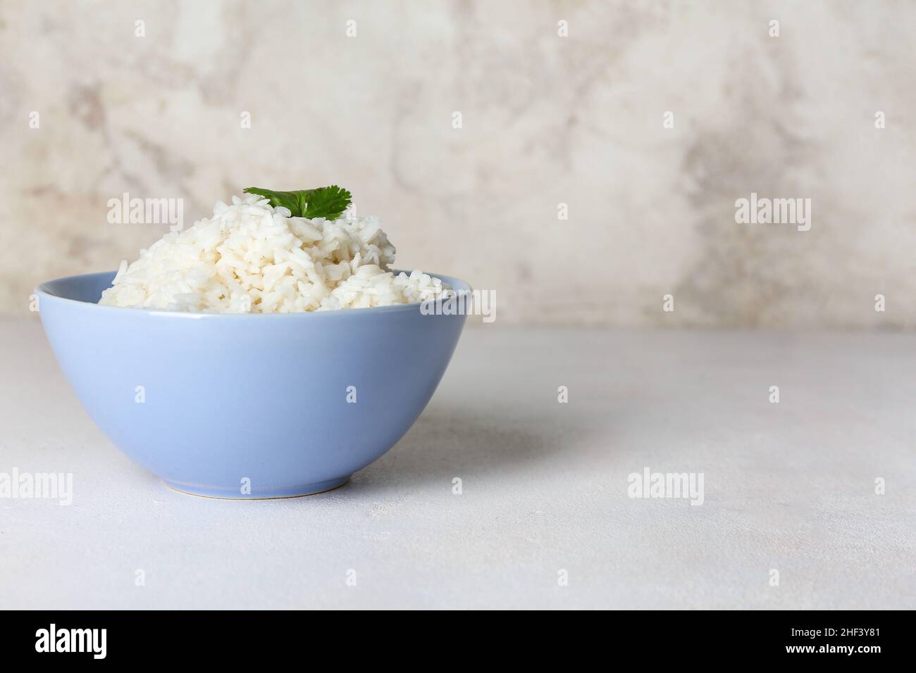 Bowl with tasty boiled rice on light background, closeup Stock Photo ...