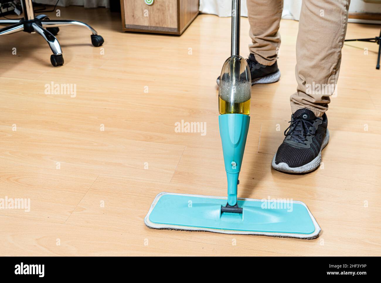 A Cleaning the floors of an office with the mop. Cleaning work Stock ...