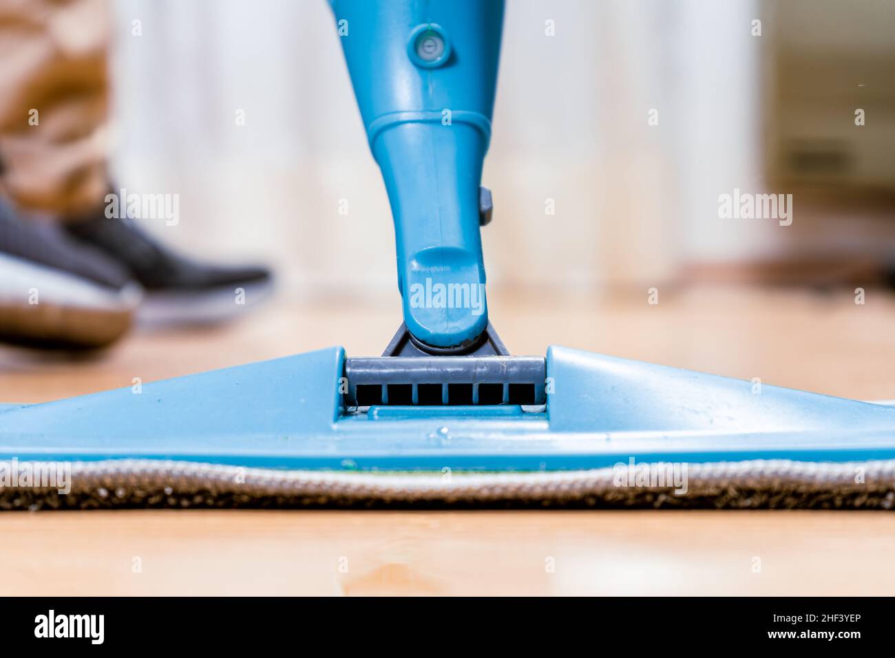 A very close-up normal view of a rectangular blue mop. Focus on the ...