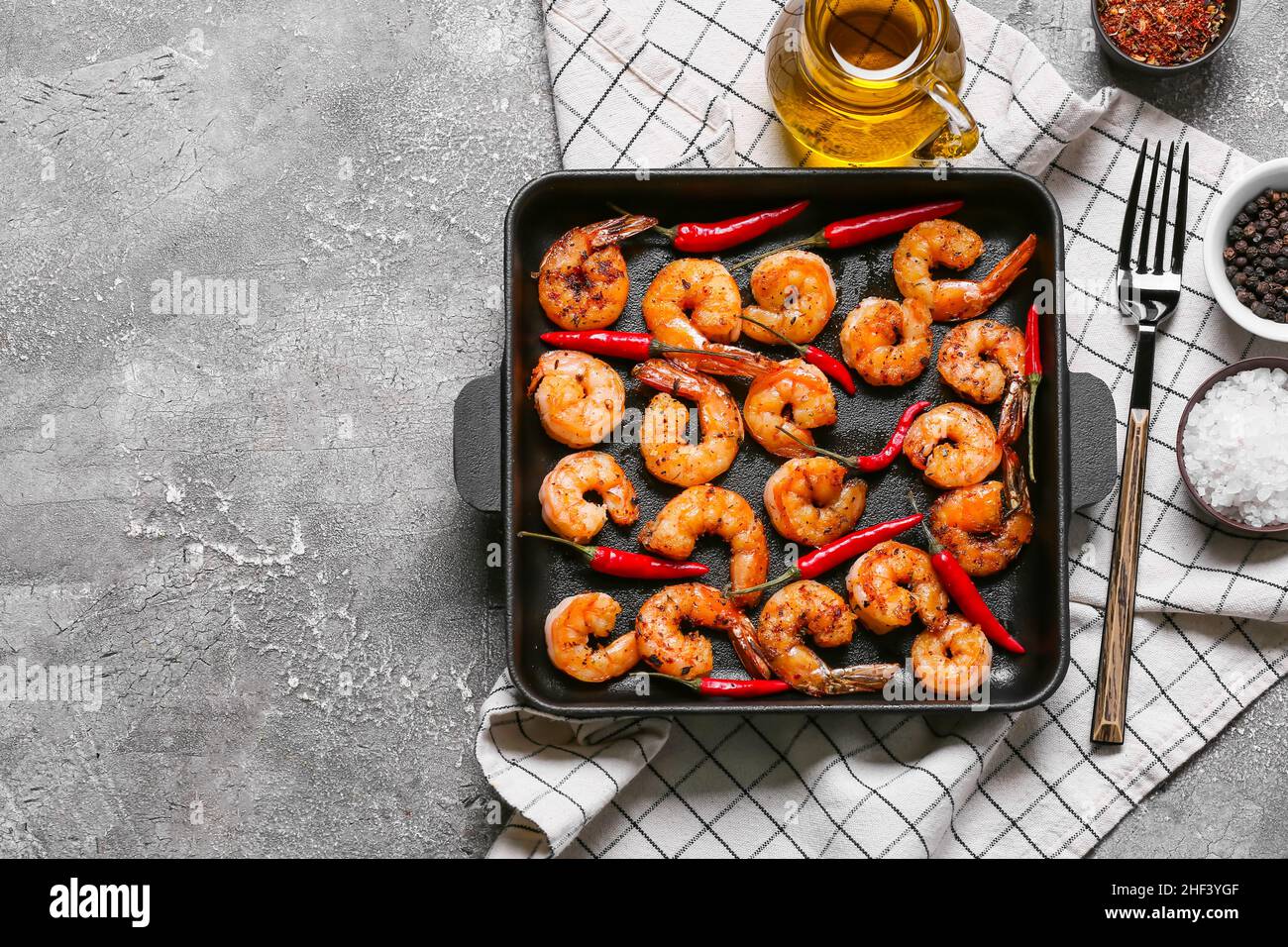 Baking dish of tasty shrimp tails on grey background Stock Photo - Alamy