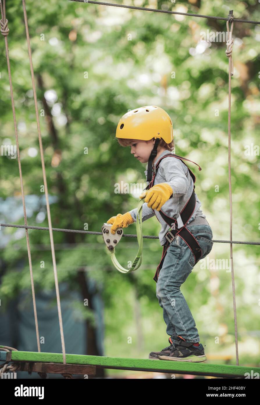 High ropes walk. Balance beam and rope bridges. Happy Little child ...