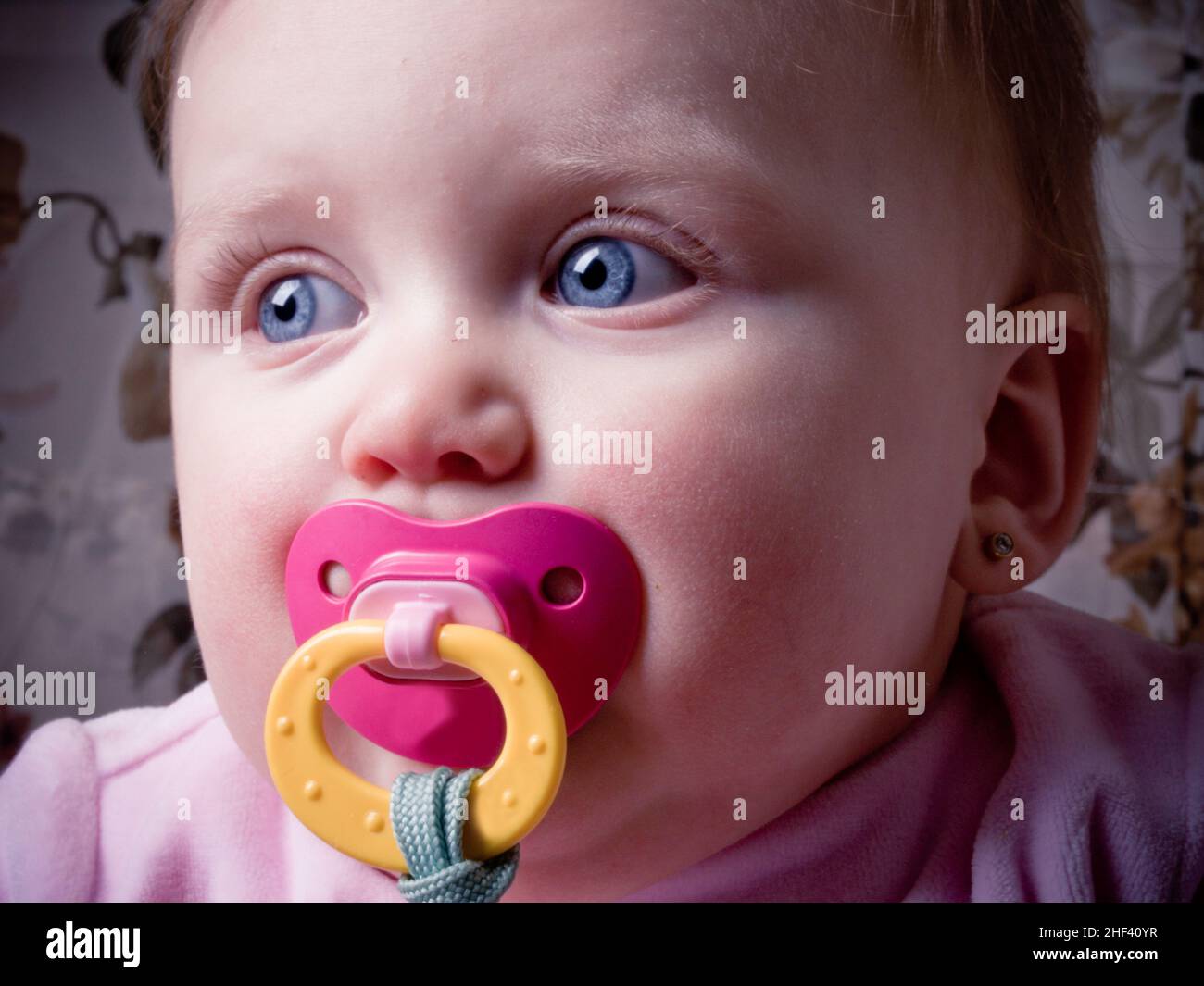 Baby Face sucking on binky, pacifier Stock Photo - Alamy