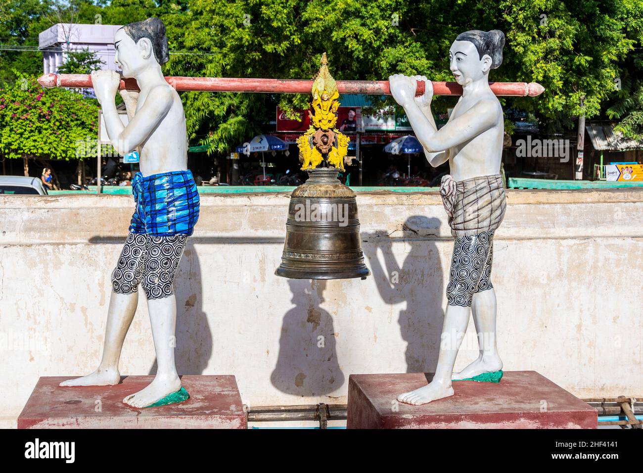 Two man statue holding a bell in Burma Stock Photo - Alamy