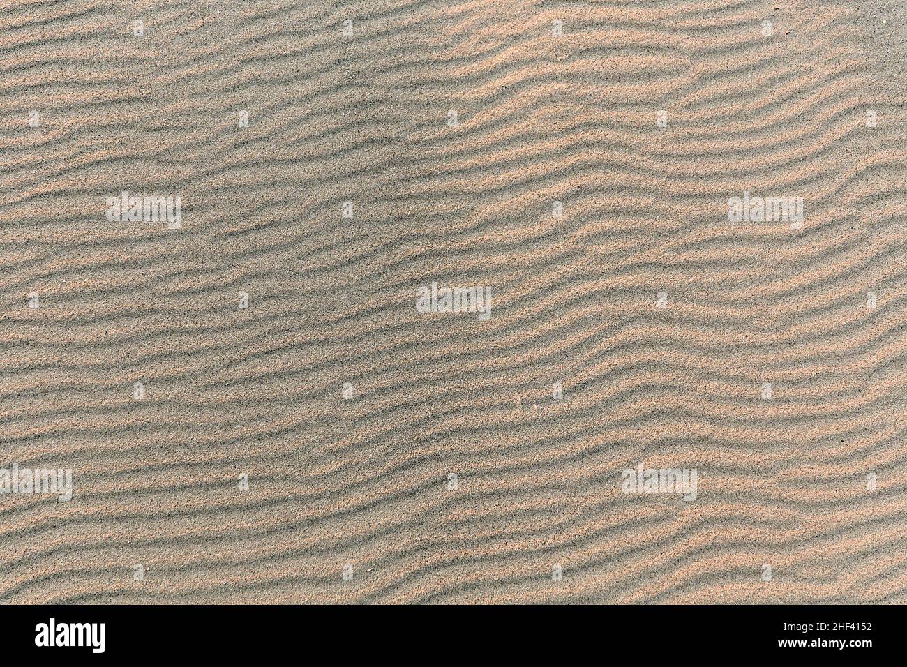 beautiful waves at he sandy beach gives a harmonic pattern in morning ...