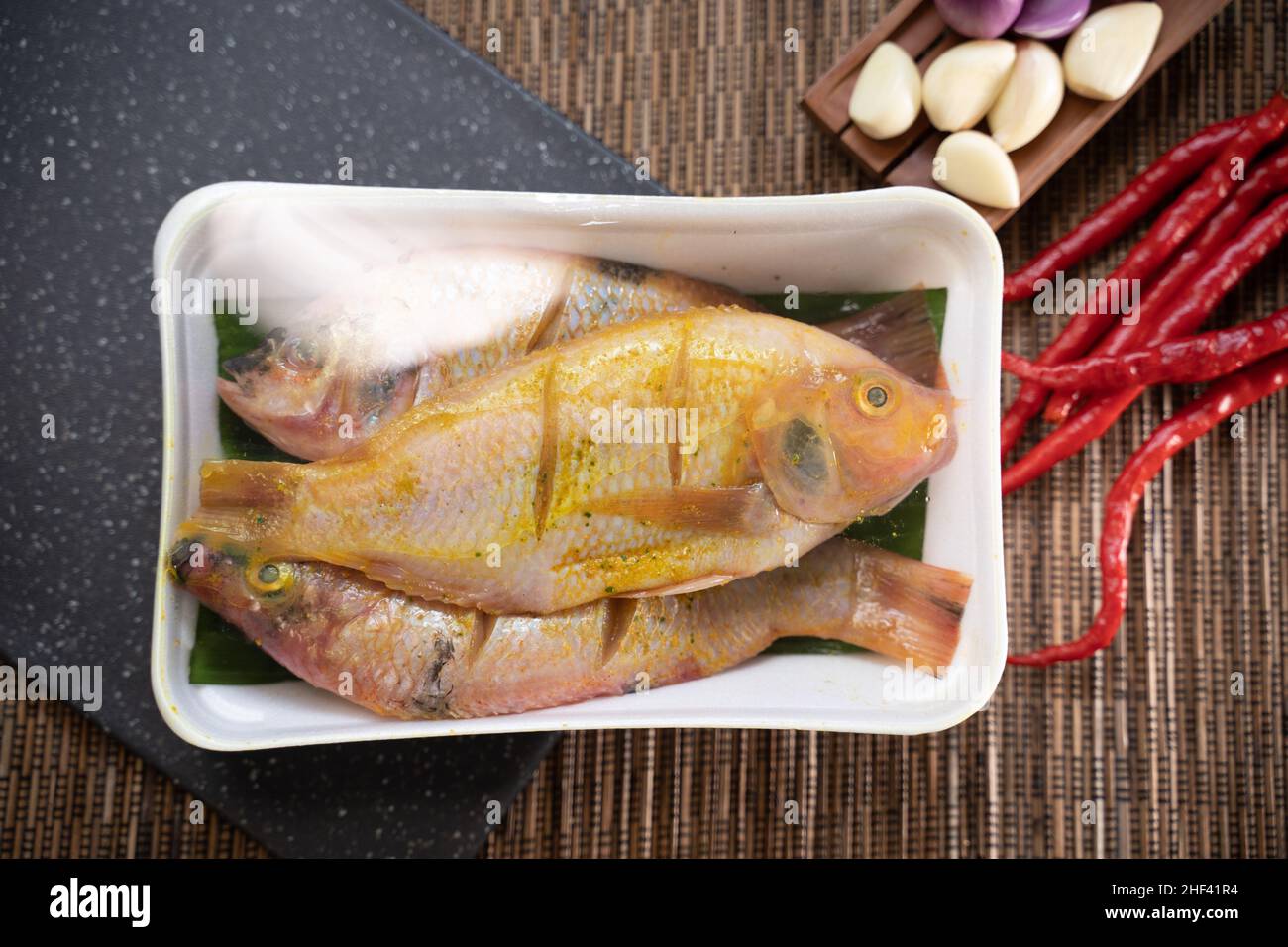 Protein source fish wrapped in polyethylene polymer foam packaging ...