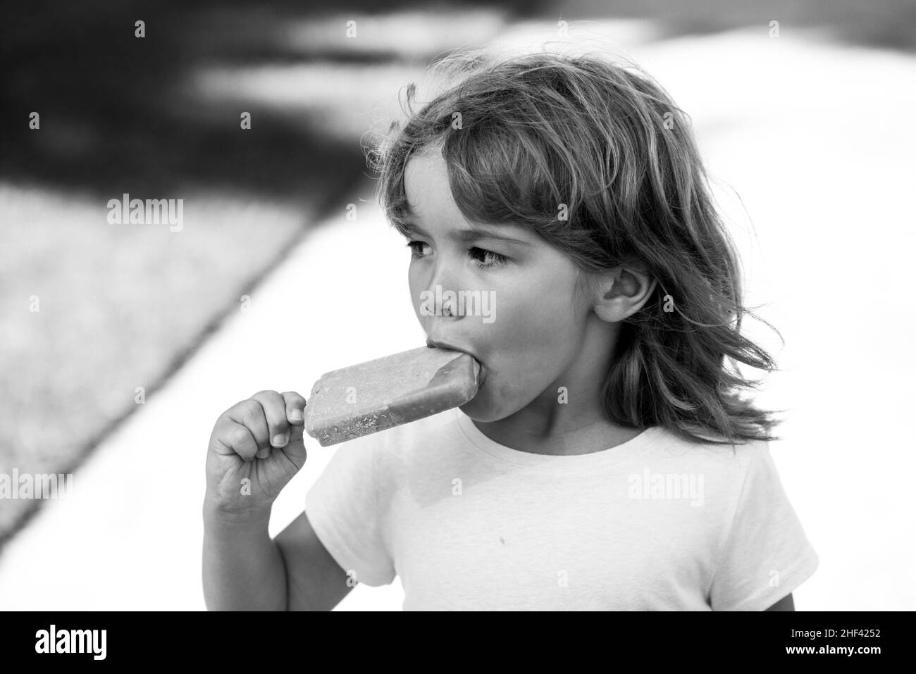 Funny child eating ice cream, face. Kids head portrait Stock Photo - Alamy
