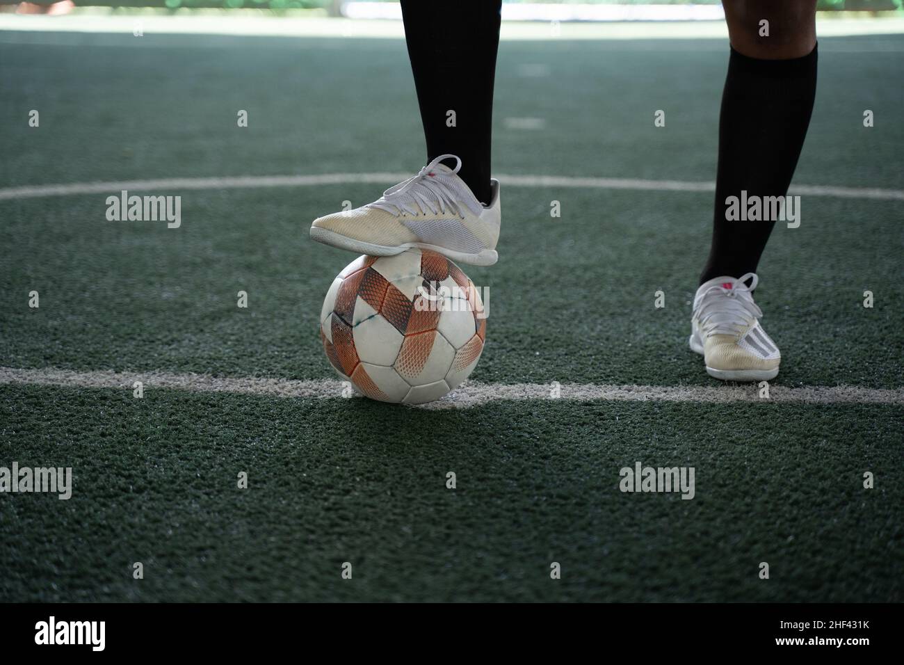 Close up of futsal player's feet stepping on the ball Stock Photo - Alamy