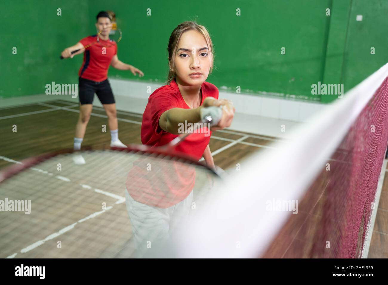Female badminton player netting when receiving a shuttlecock Stock ...
