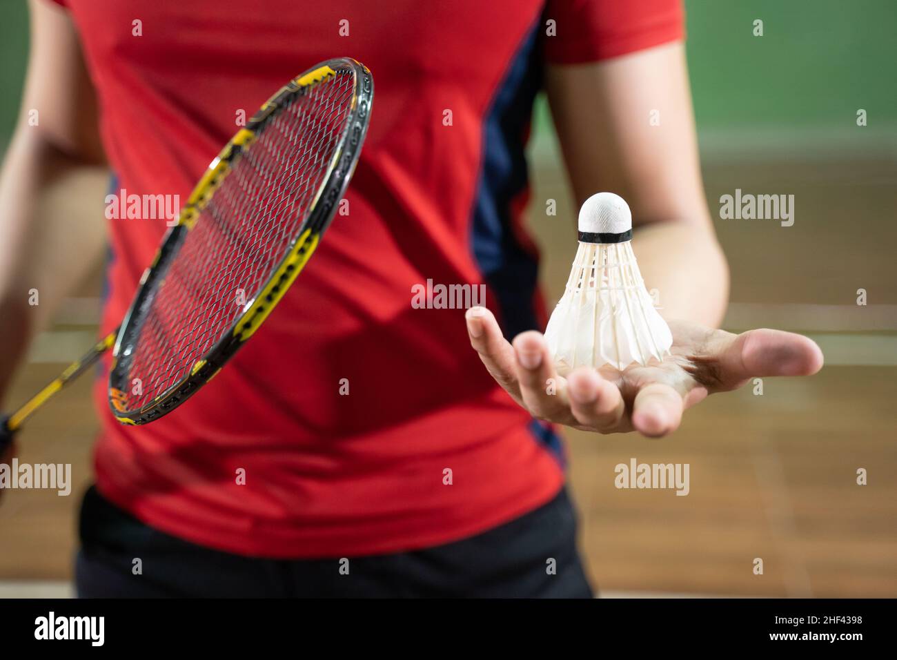 Badminton player in red shirt holding racket and shuttlecock Stock ...