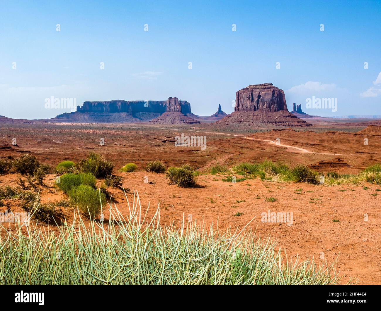 giant sandstone buttes in the Monument valley under blue sky Stock ...