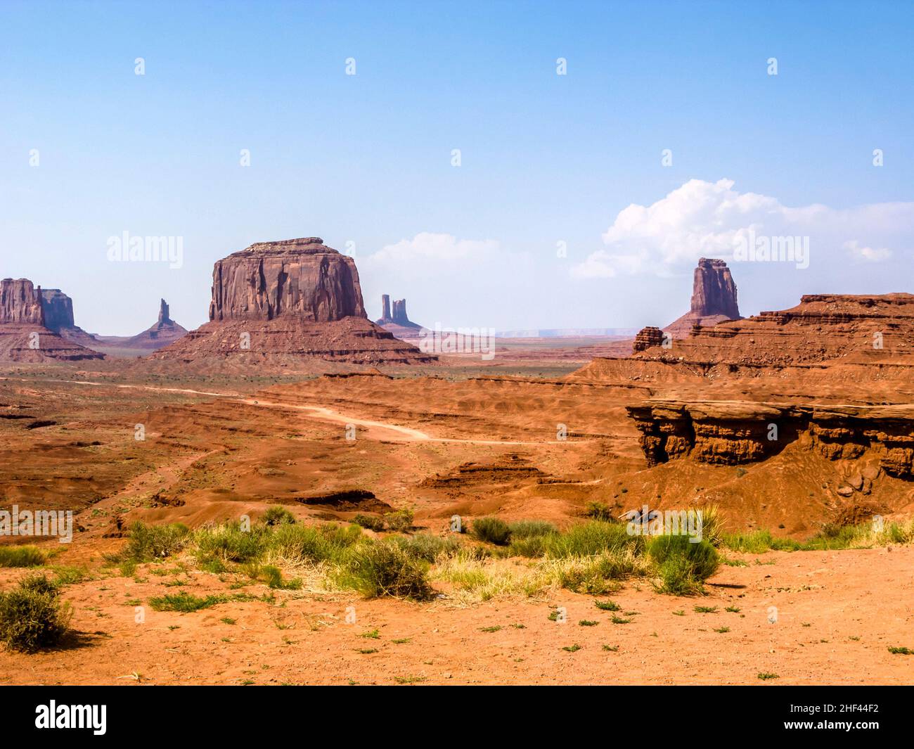 giant sandstone buttes in the Monument valley under blue sky Stock ...