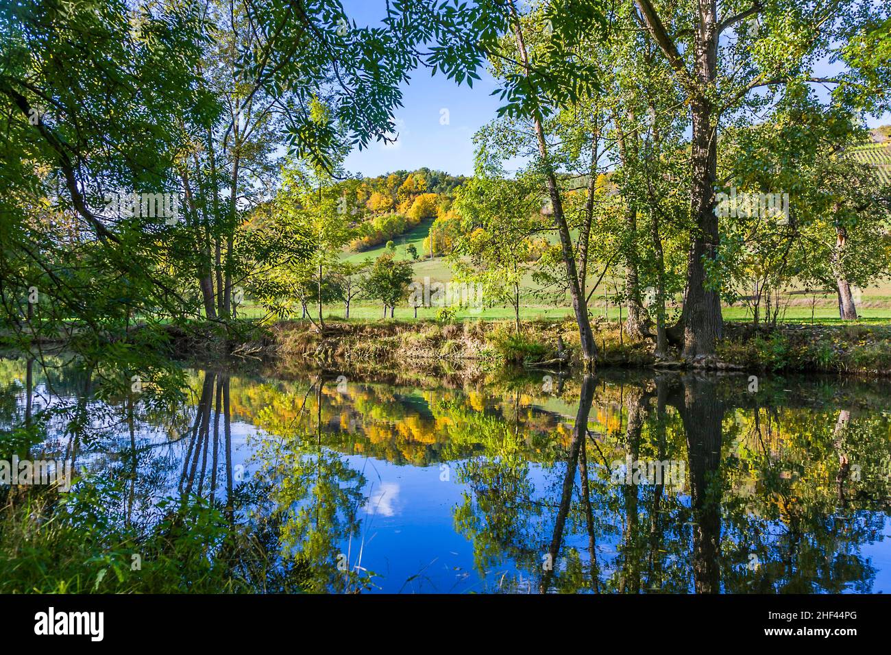 reflection in the river Tauber in lovely Tauber valley near Rothenburg ...