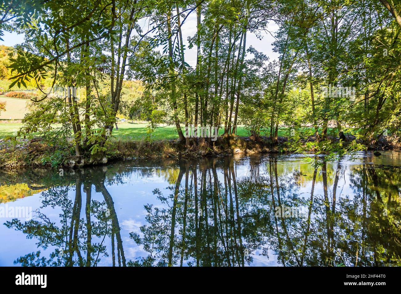 reflection in the river Tauber in lovely Tauber valley near Rothenburg ...
