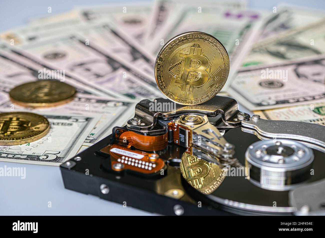 Bitcoin BTC coins, open hard drive and dollar bills, cryptocurrency and ...