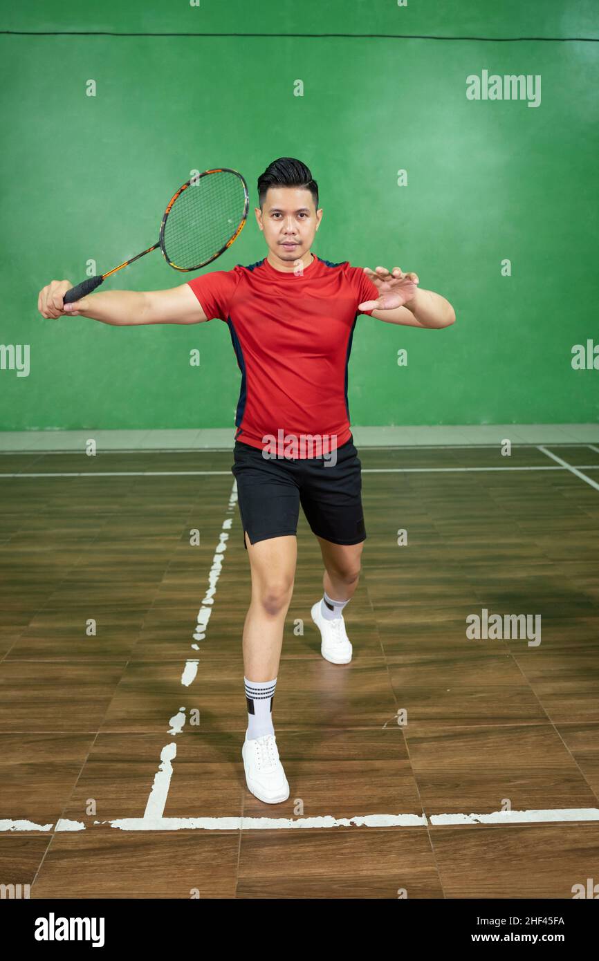 Male badminton player ready standing behind the line on court Stock ...